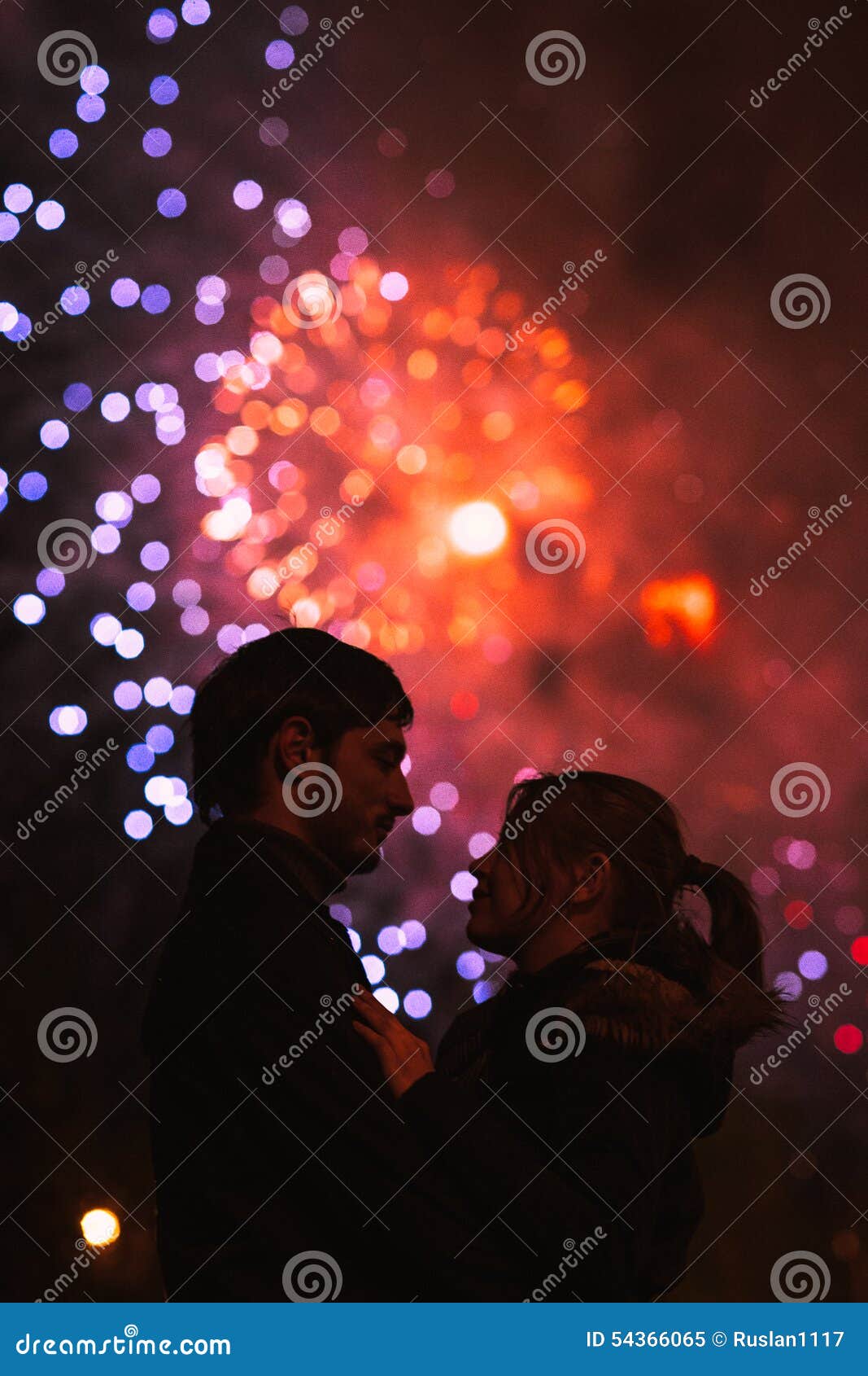 A Silhouette of a Kissing Couple in Front of a Huge Fireworks Display ...