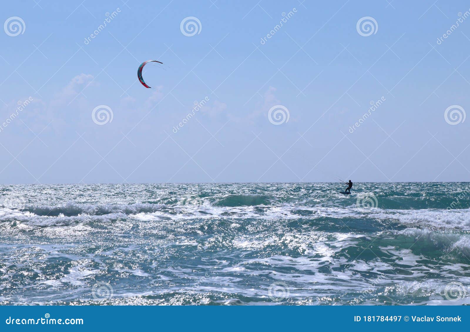 Silhouette of Kiteboarder in the Distance. Man Paddles between Waves ...