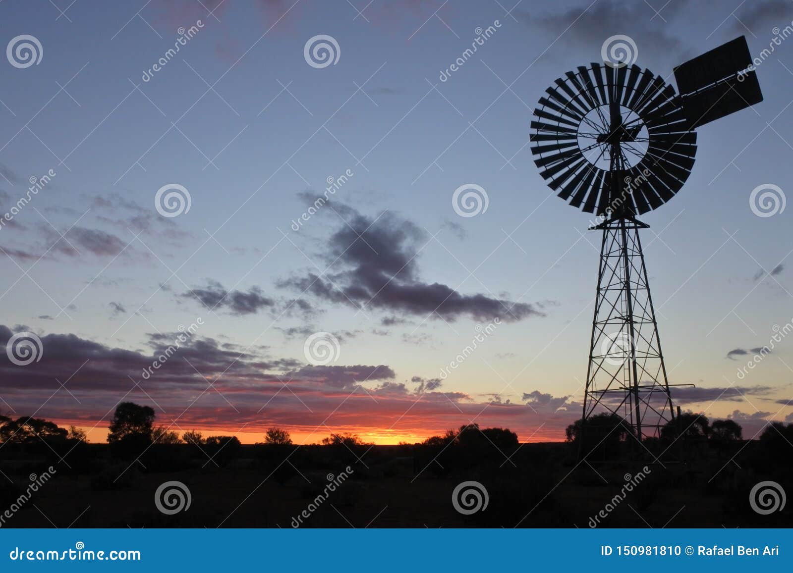 Silhouette of a Large Windmill in Central Australia Outback Stock Photo ...