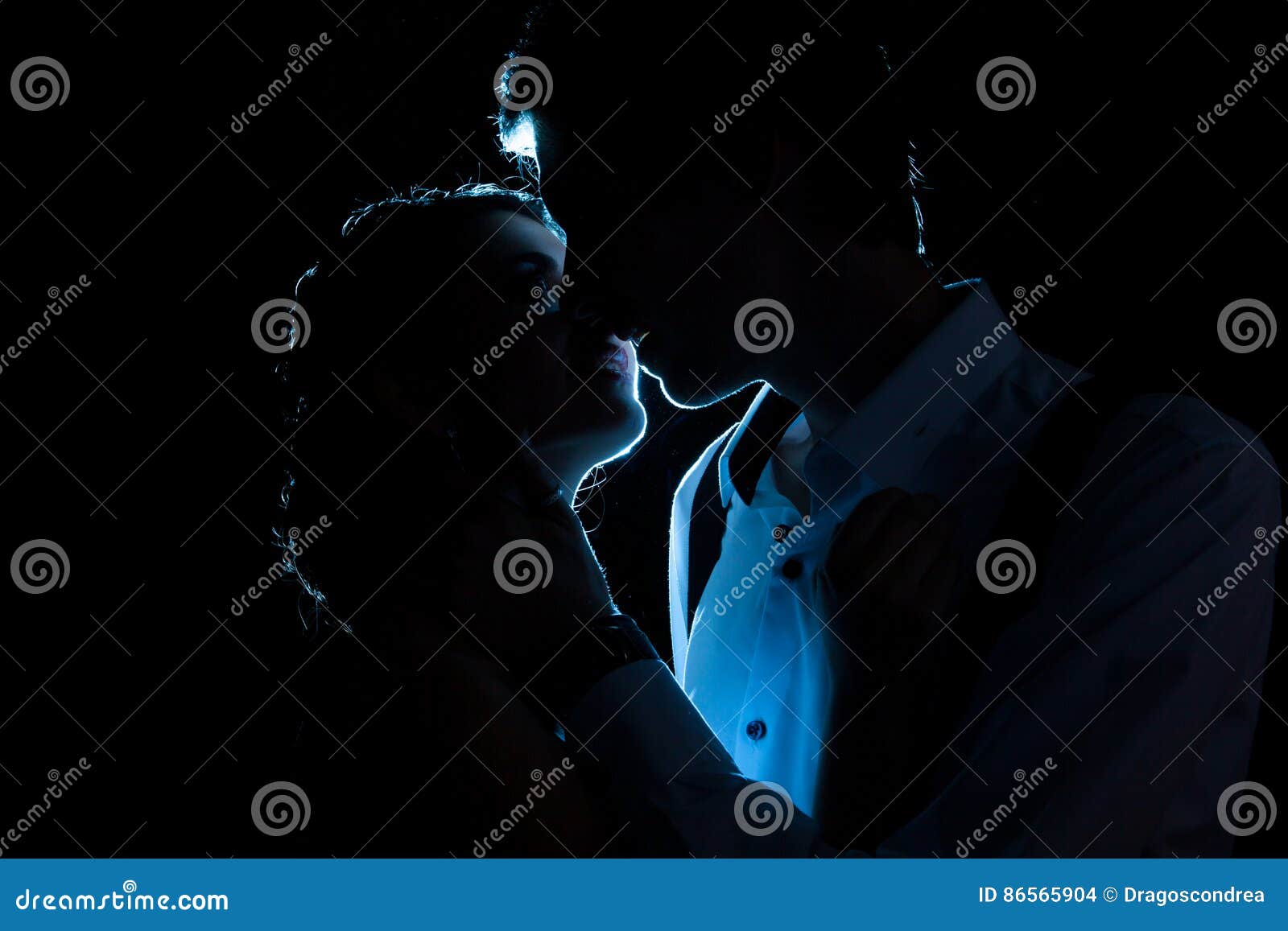 Silhouette of Loving Couple with a Blue Light Behind Stock Photo ...