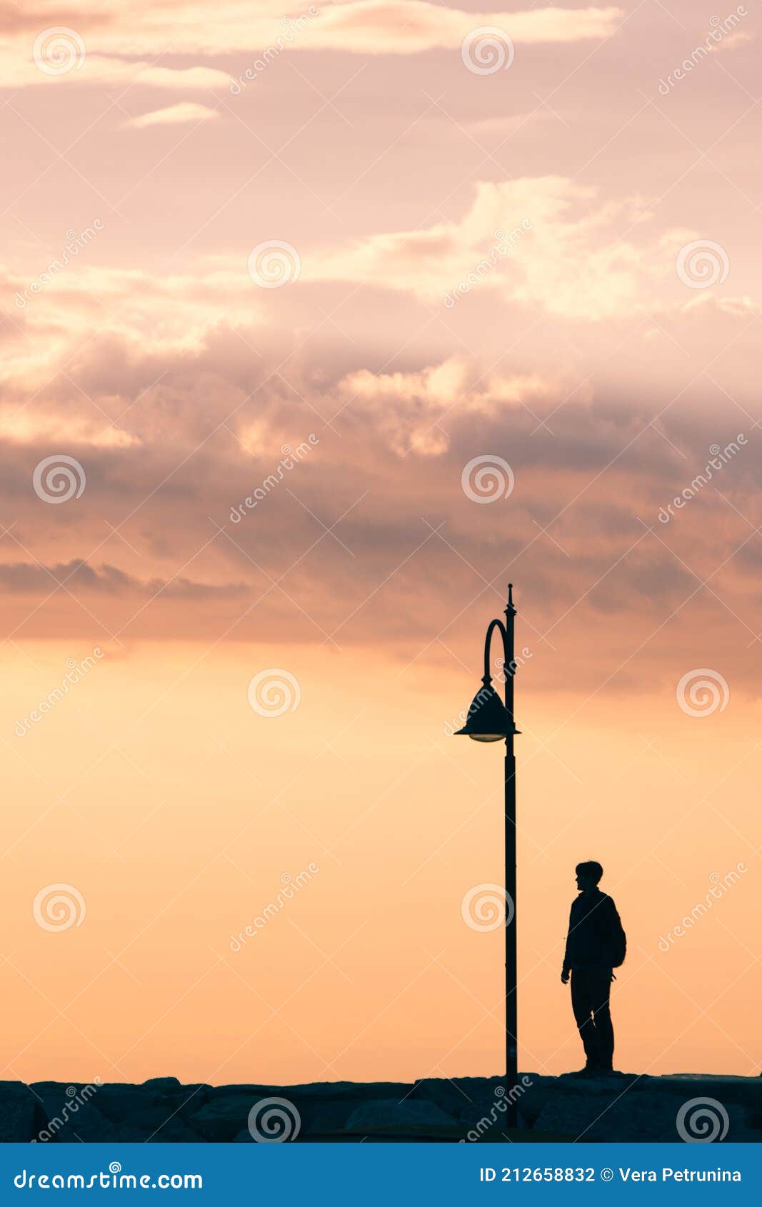 Silhouette of Man with City Lighter on Sunset Orange Pink Clouds Stock ...