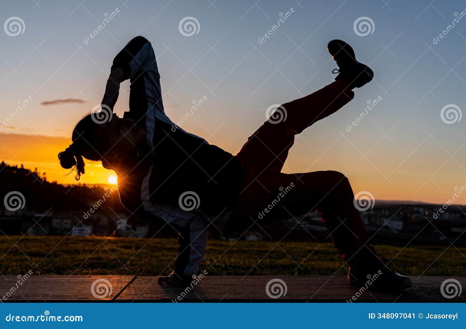 Silhouette of a Man Doing a Breakdance Position in Front of a Sunset ...