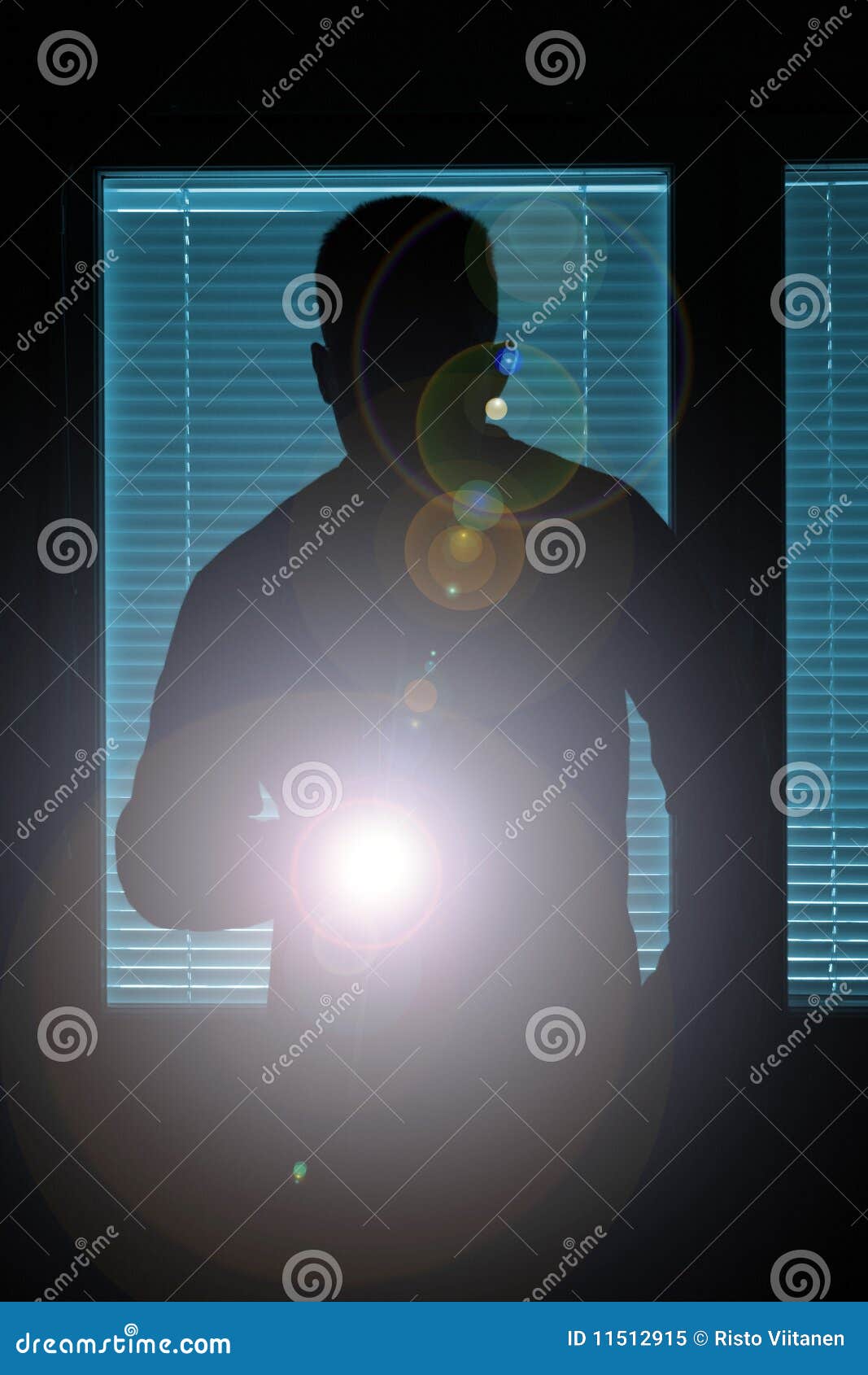 Silhouette Of A Man With Flashlight On His Head Pointing Bright Beam Of ...