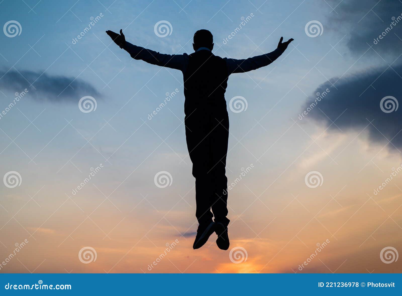 Silhouette of Man Float in Sunrise Sky with Raised Hands, Freedom Stock ...