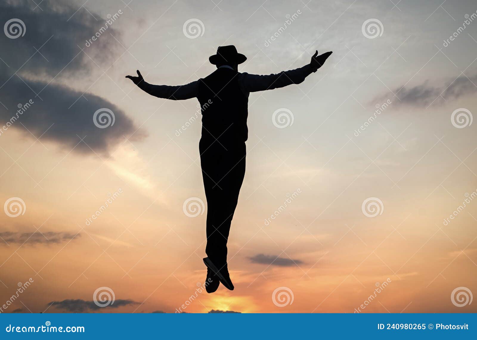 Silhouette of Man Float in Sunrise Sky with Raised Hands, Freedom Stock ...