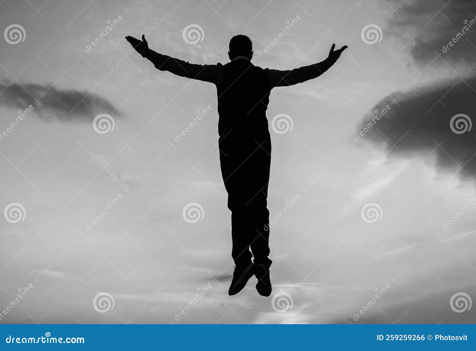 Silhouette of Man Float in Sunrise Sky with Raised Hands, Freedom Stock ...