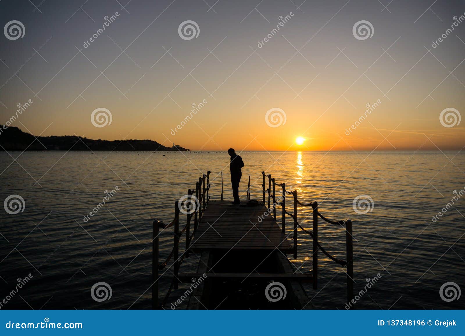 Silhouette of a Man Getting Ready for Swimming in Seaside on Sunset ...