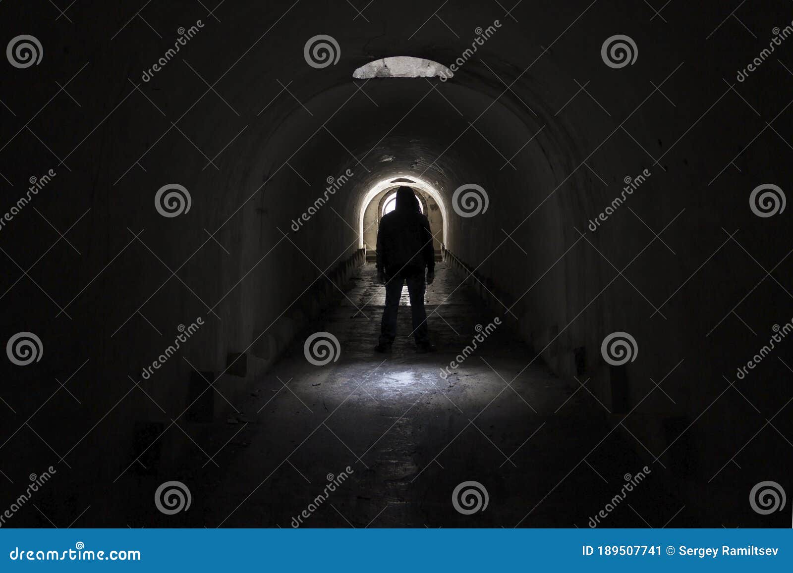 A Silhouette of a Man Going To the Exit To the Lighted Door from a ...