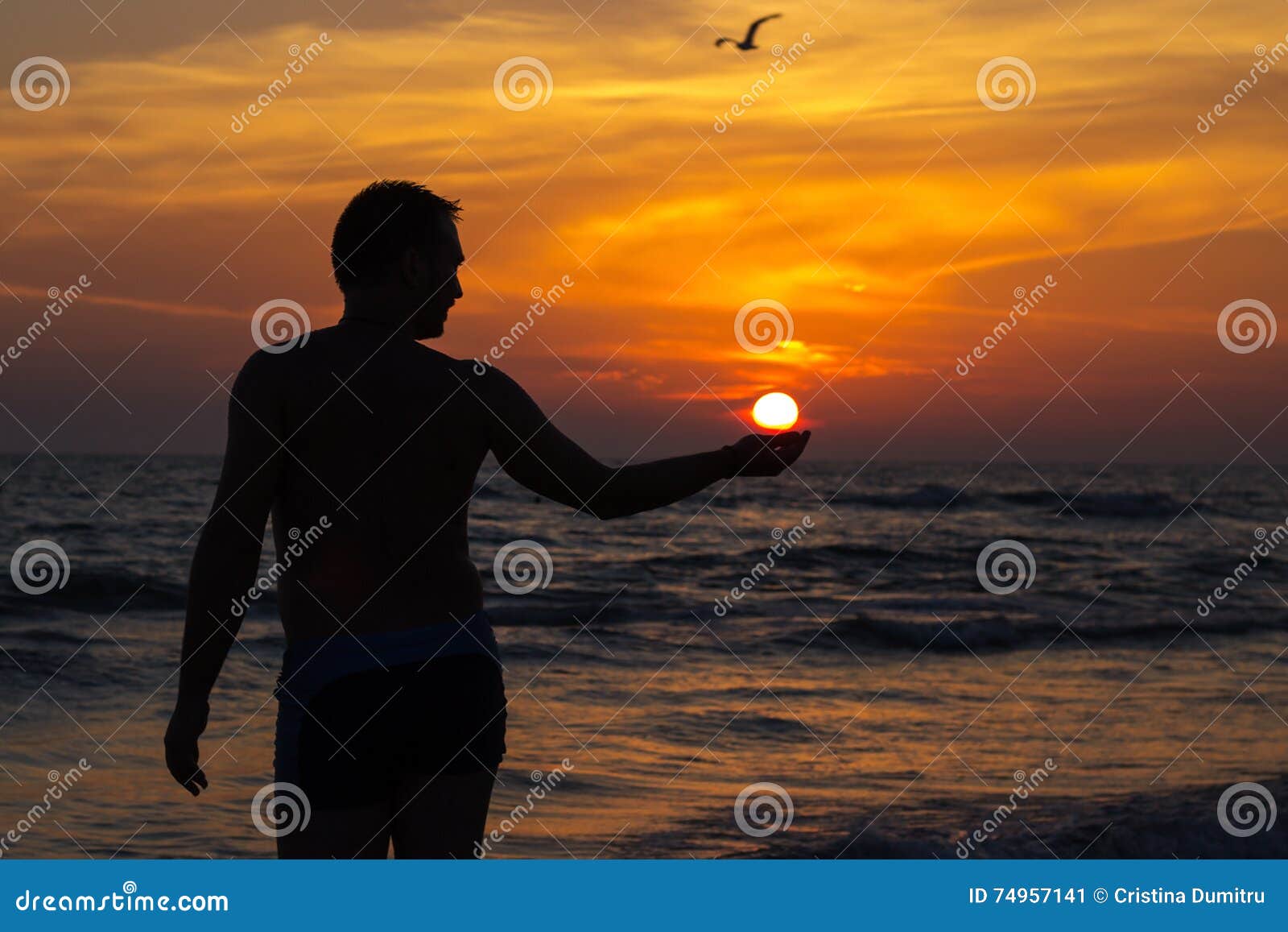 Silhouette of a Man Holding the Sun Stock Image - Image of male, beach ...