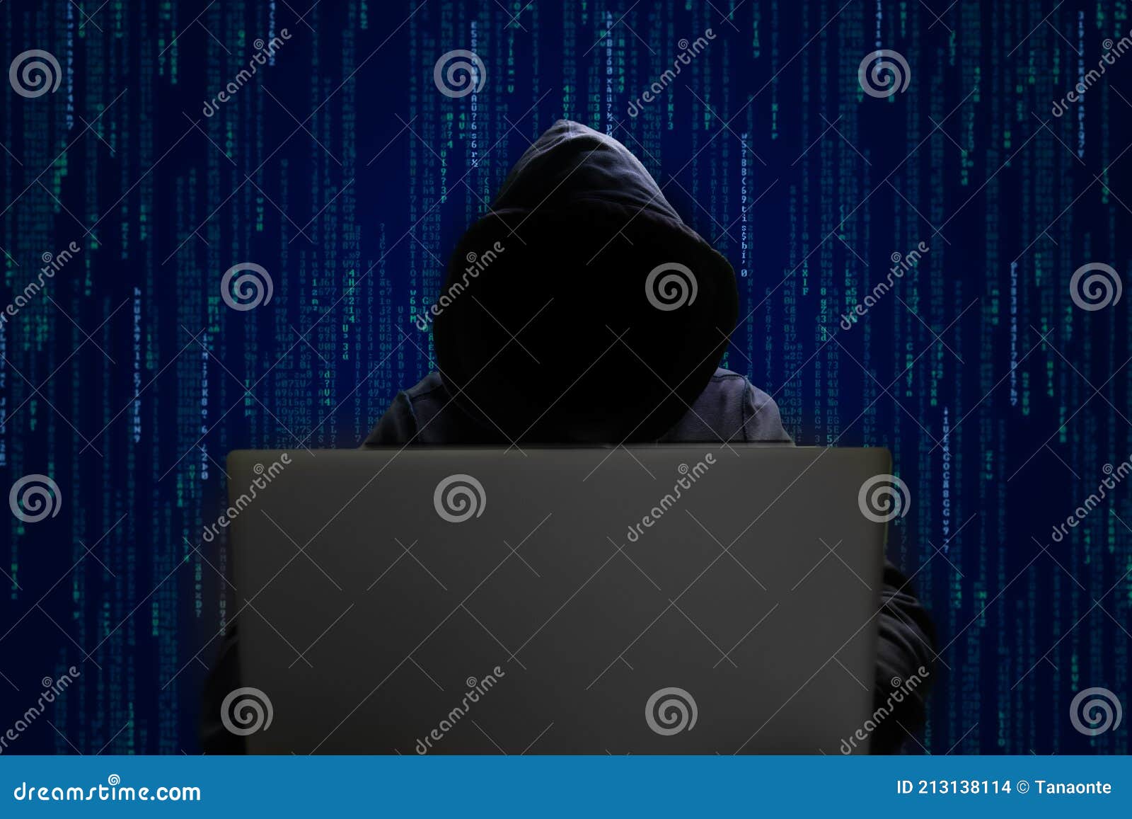 Silhouette of a Man in a Hood Working As a Hacker at the Computer in ...