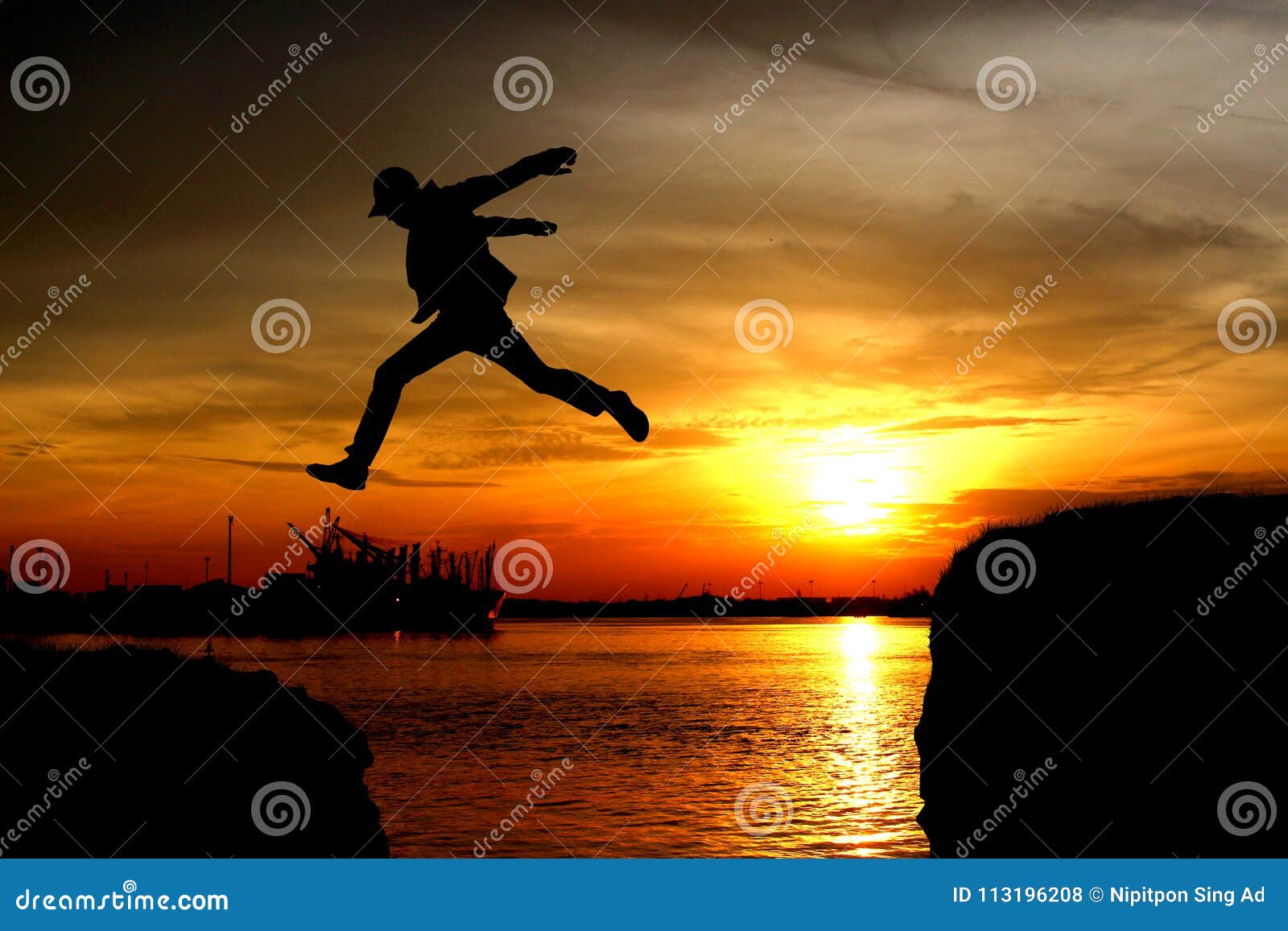 Silhouette of a Man Jumping Over the Cliff Stock Photo - Image of back ...