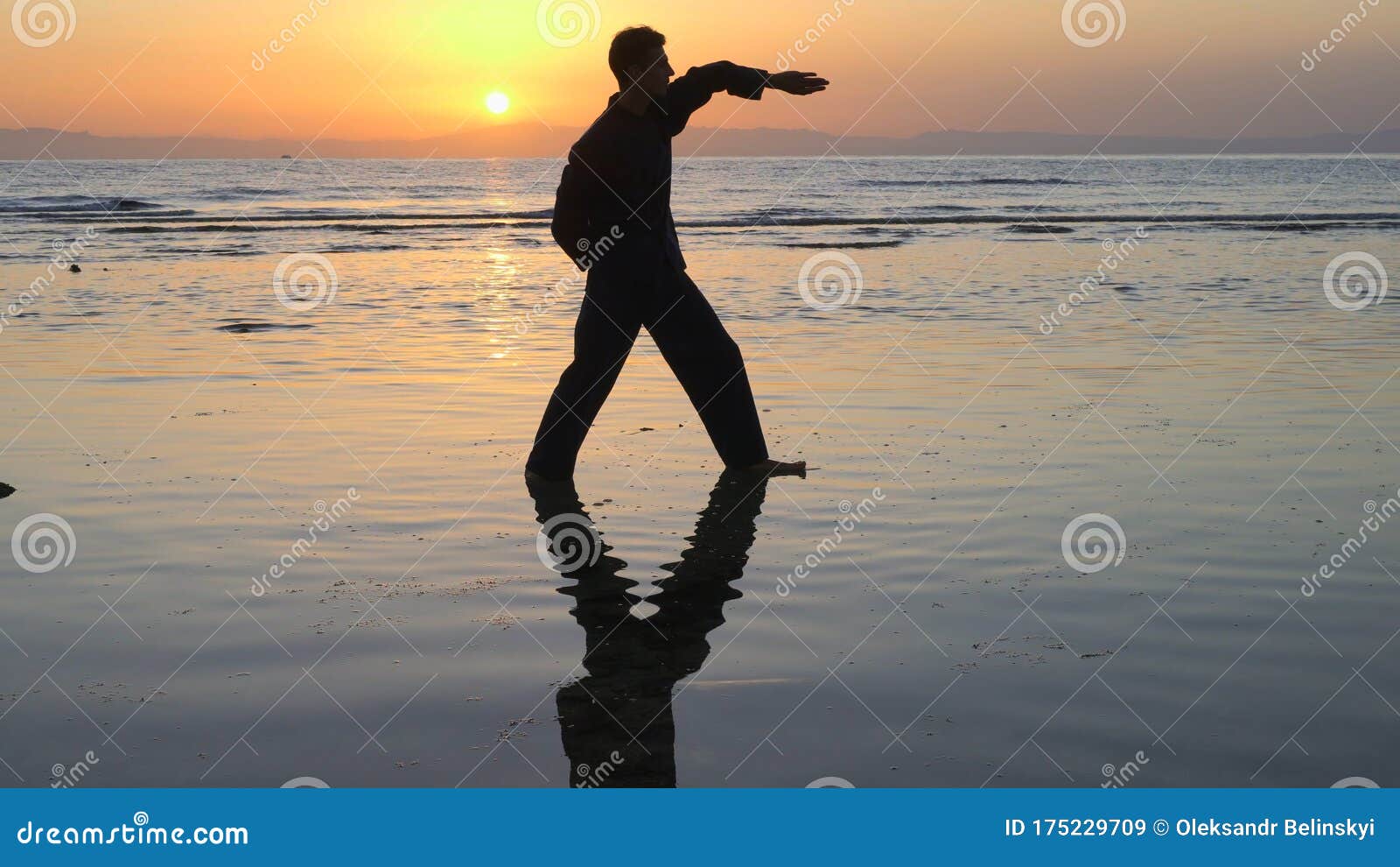 Silhouette of Man Practicing Energy Exercises at Sunset by the Sea ...