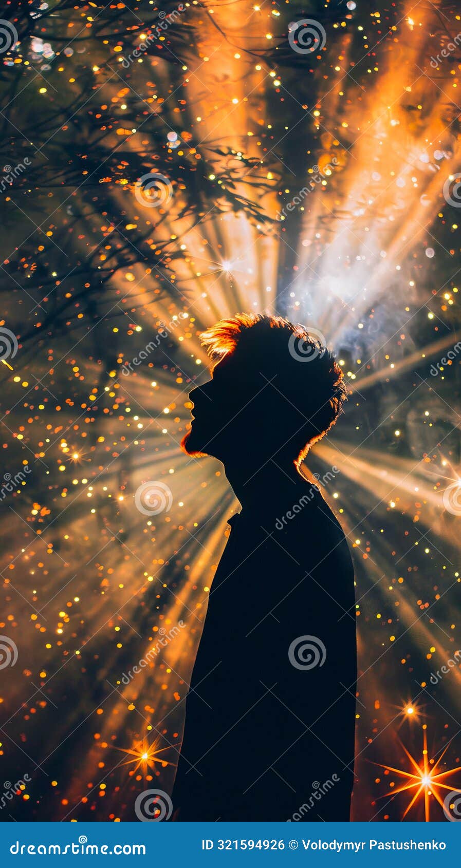 A Silhouette of a Man Standing in Front of Rays of Light Stock ...