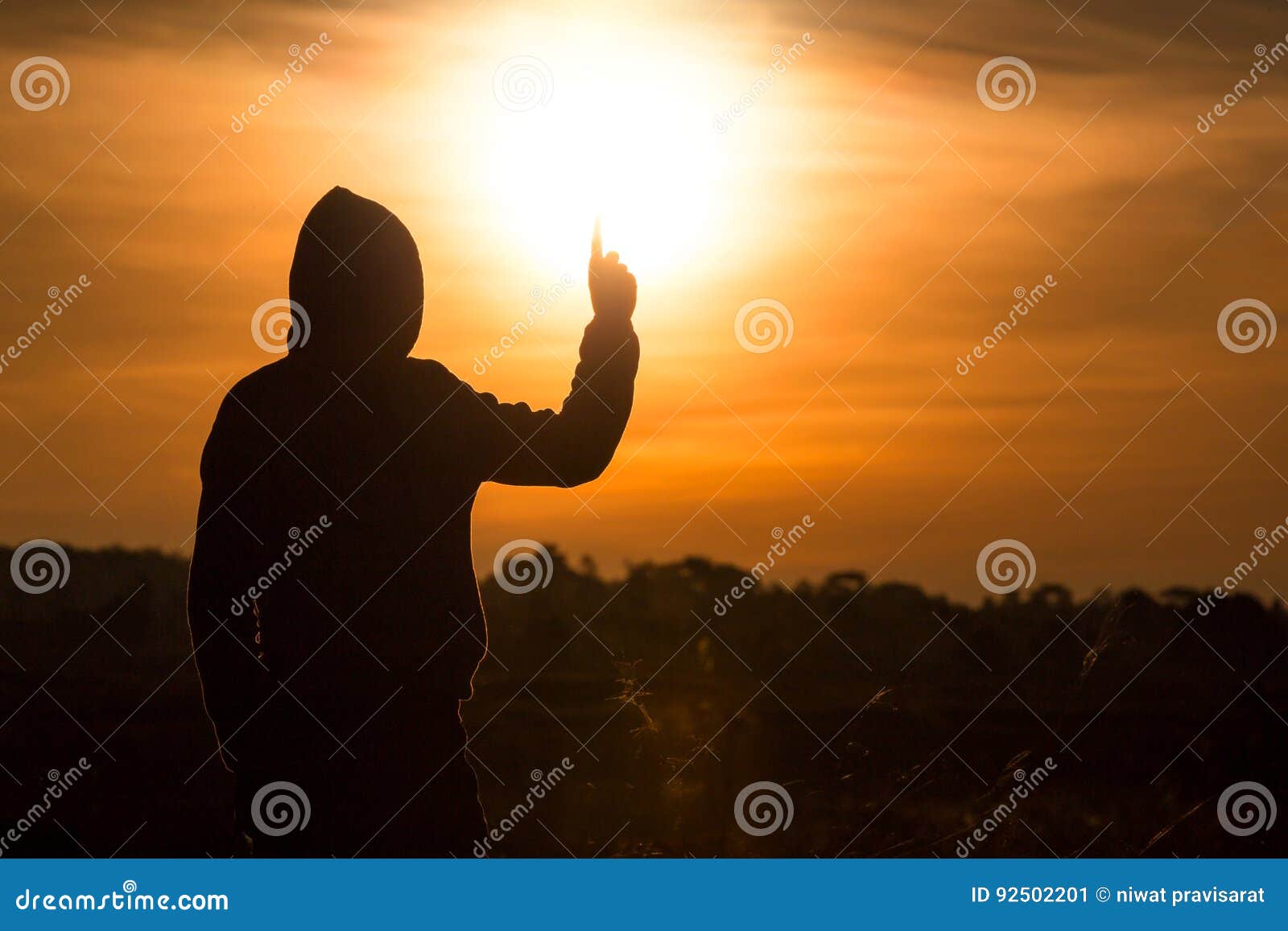 Silhouette of a Man Standing and Rise His Hands Up in the Air Du Stock ...