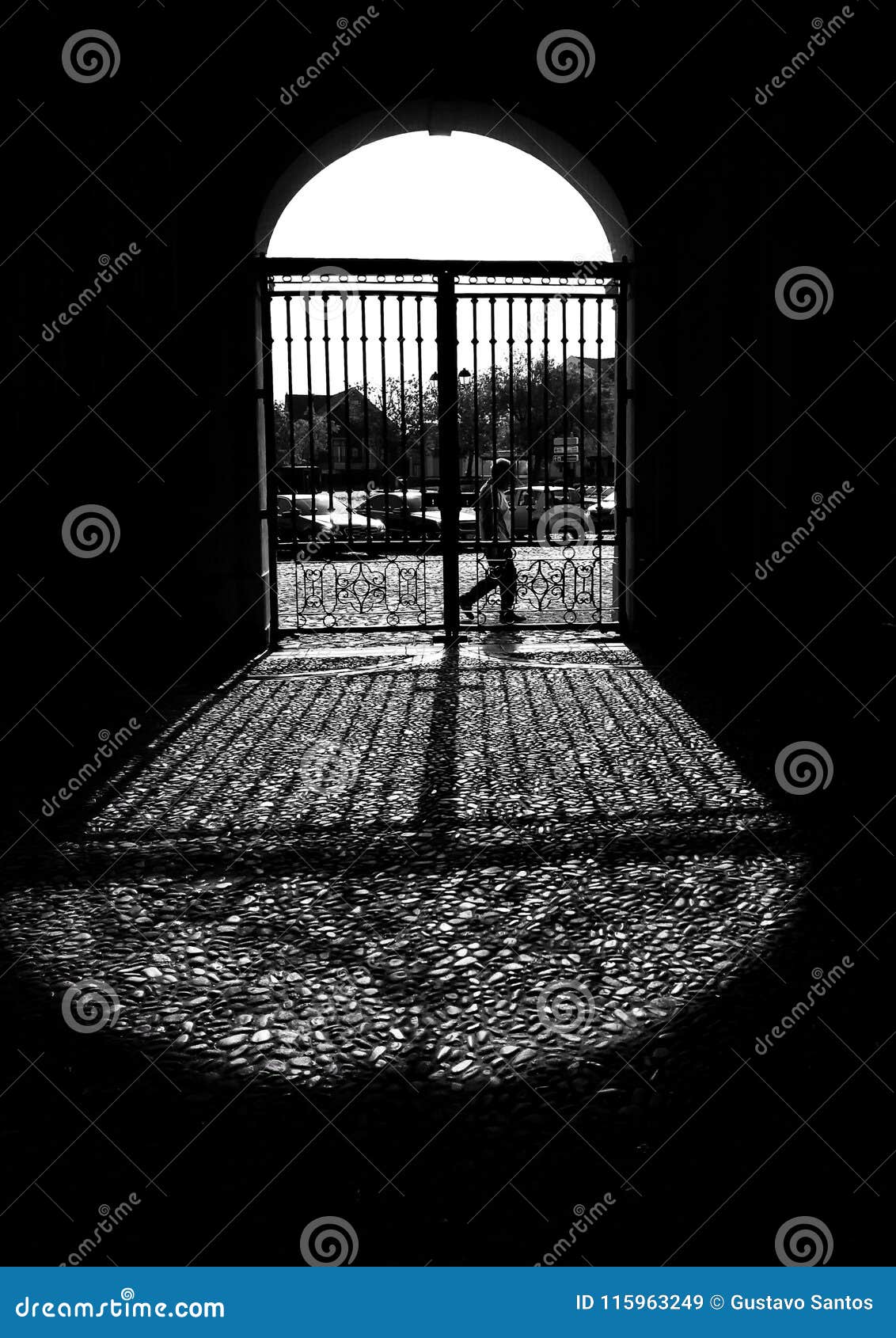 Silhouette of a Man Walking Behind a Gate Stock Image - Image of light ...