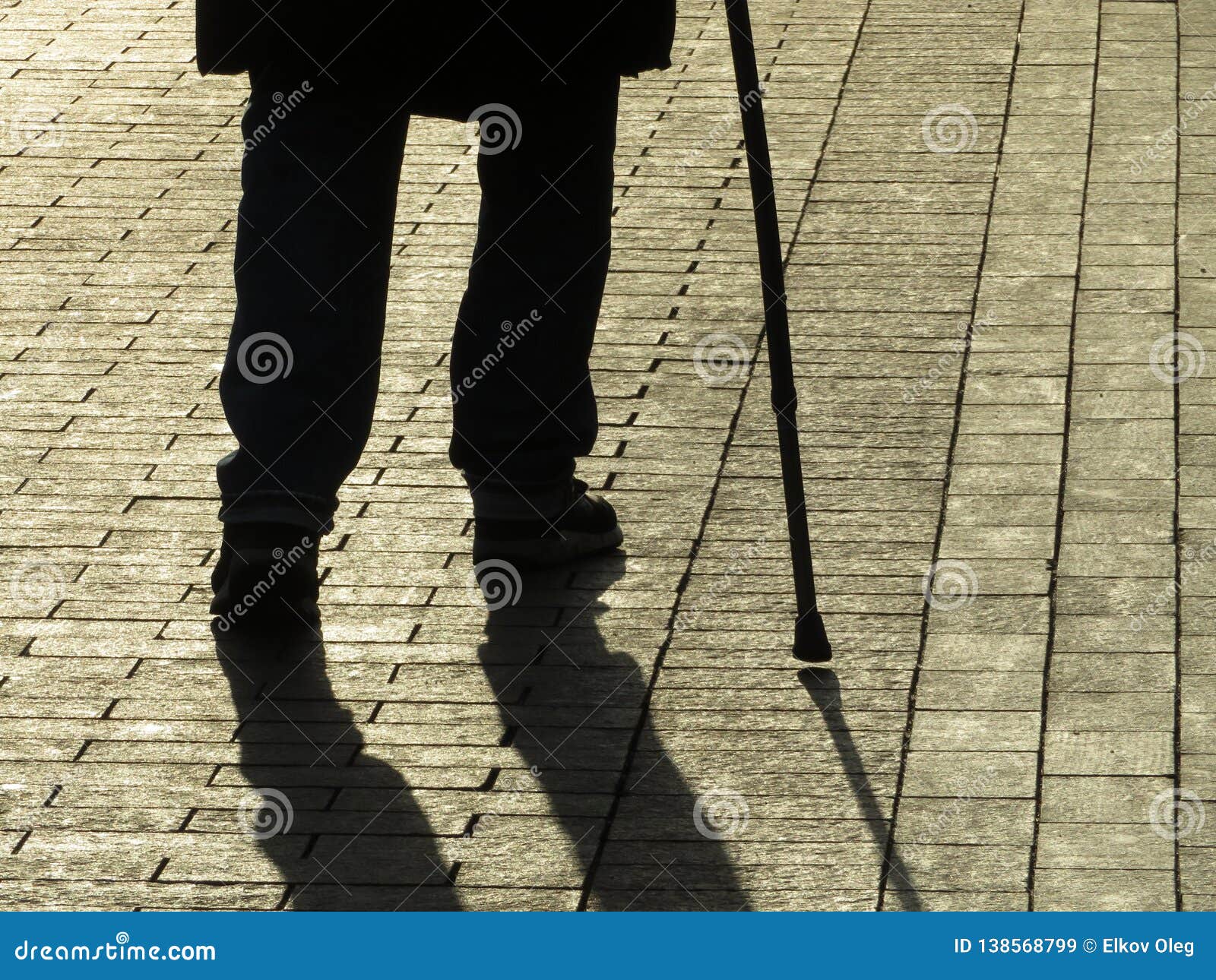 Silhouette of Man Walking with a Cane, Long Shadow on Pavement Stock ... Silhouette of Man Walking with a Cane, Long Shadow on Pavement Stock ...