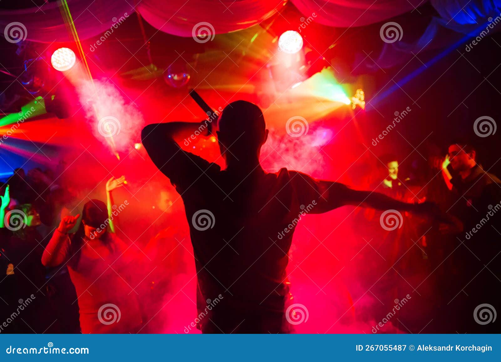 Silhouette of the MC with a Microphone on Stage of Nightclub Stock ...