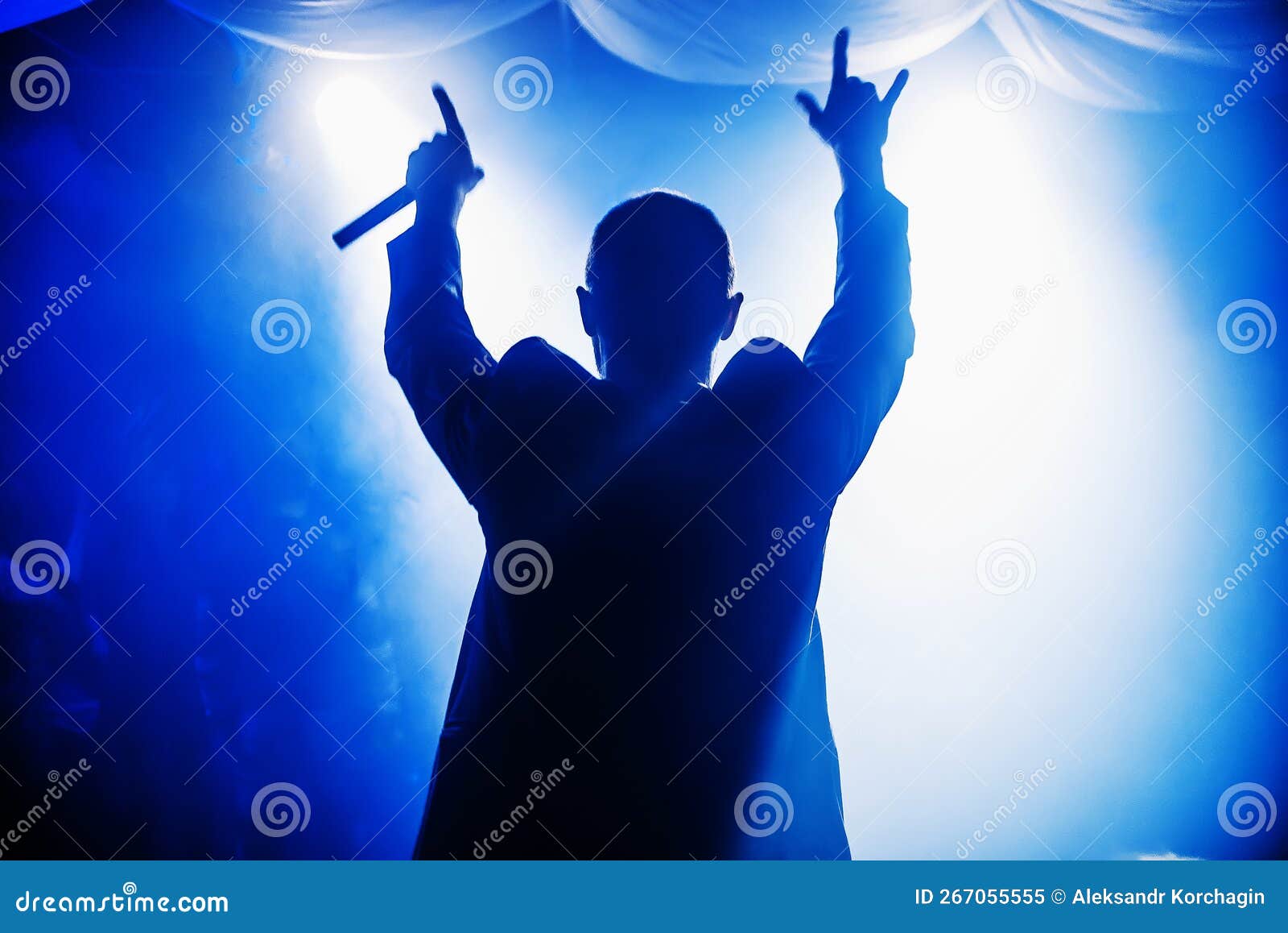 Silhouette of the MC with a Microphone on Stage of Nightclub Stock ...