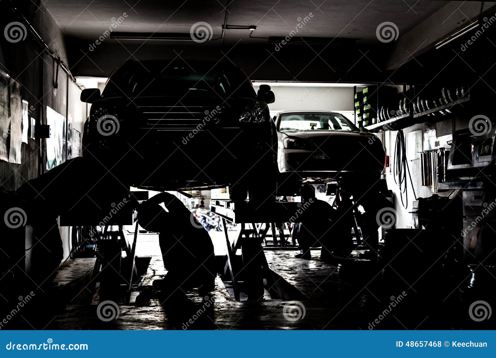 Silhouette of Mechanics Servicing Cars at a Small Workshop Stock Photo ...
