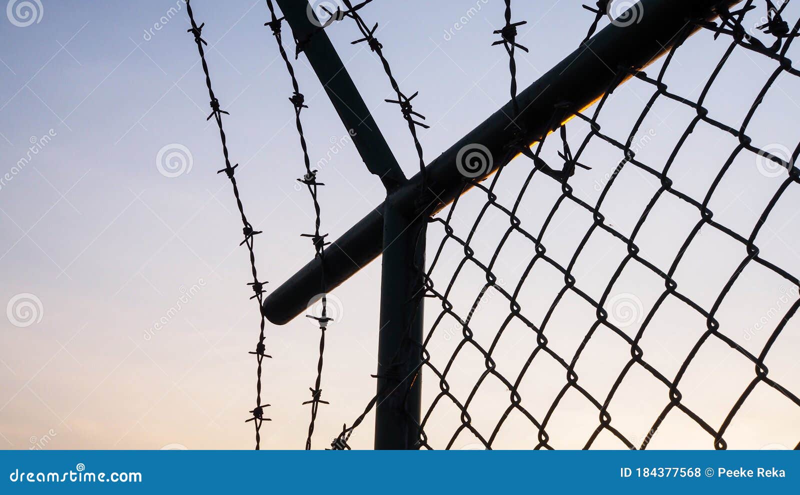 Metal Mesh Fence and Barbed Wire Mesh at Sunset Stock Photo - Image of ...