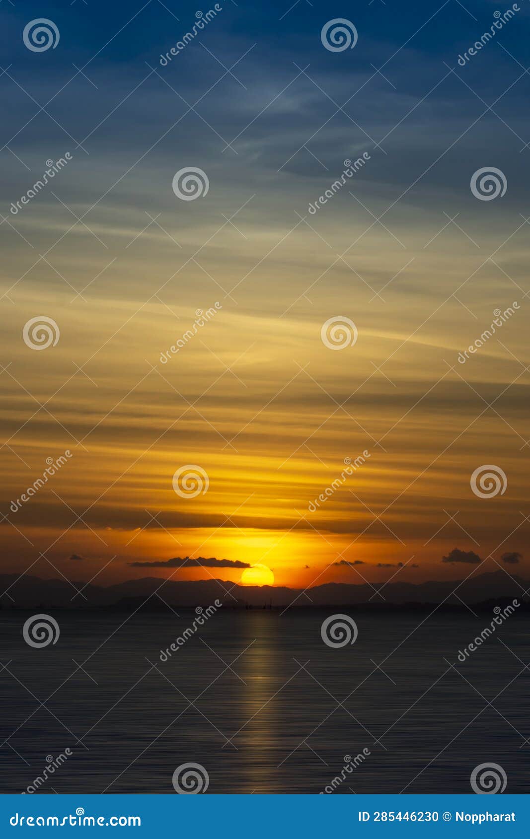 Silhouette Mountain with Sun and Line Clouds in Sunset Sky Stock Photo ...