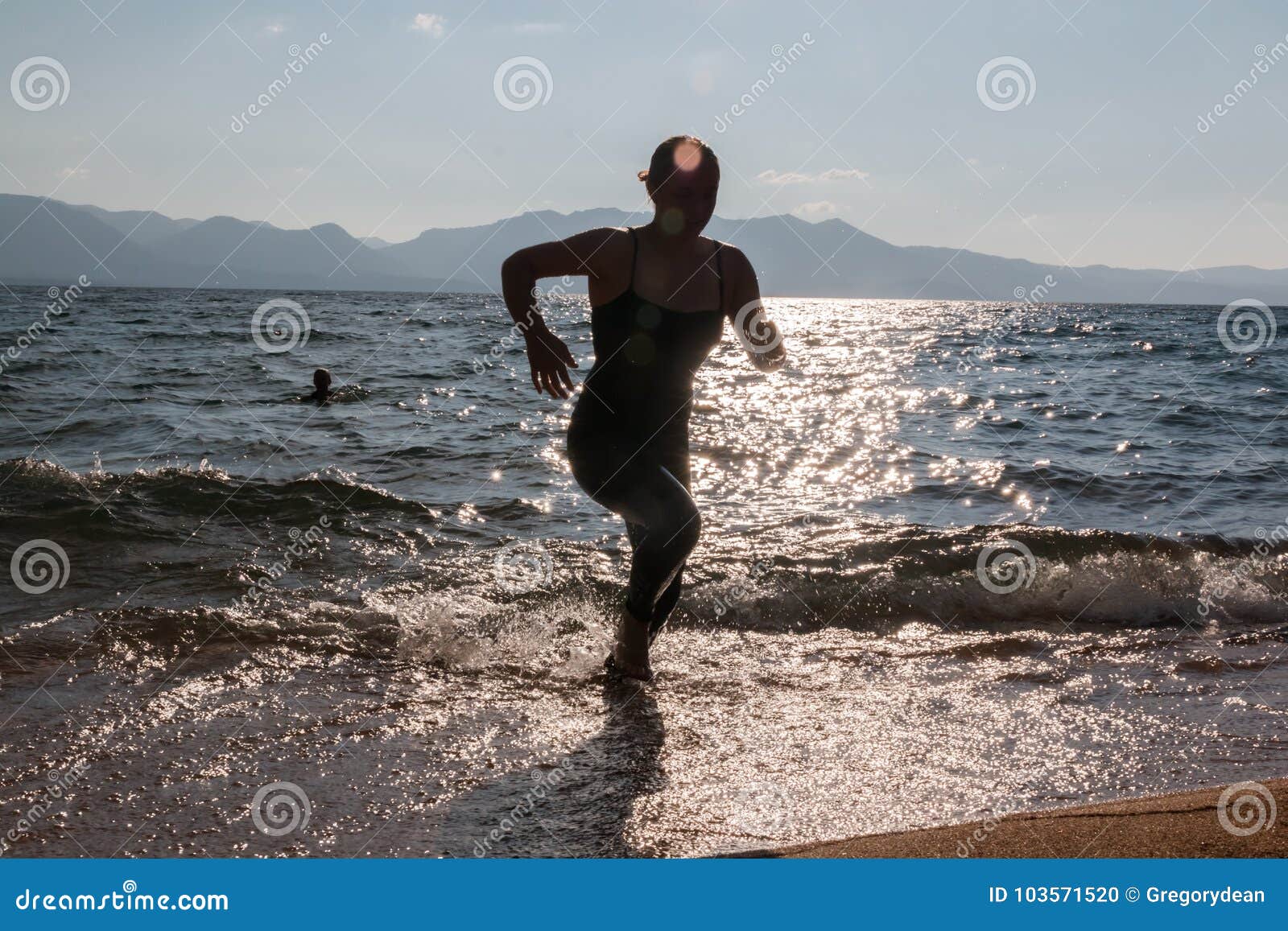 Silhouette of One Girl Running through the Waves Stock Photo - Image of ...