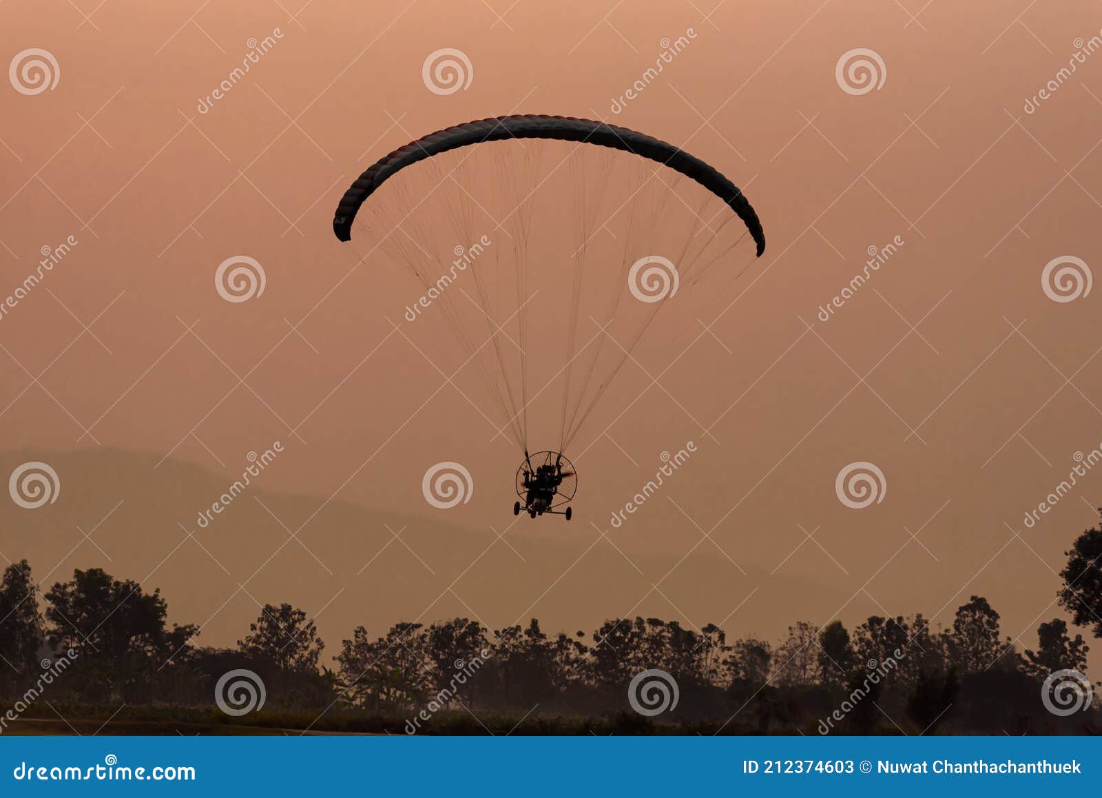 Silhouette of the Paramotor Gliding and Flying in the Air through Soft ...