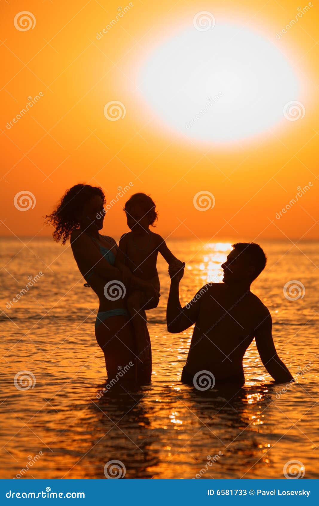 Silhouette of Parents with Child in Sea on Sunset Stock Image - Image ...