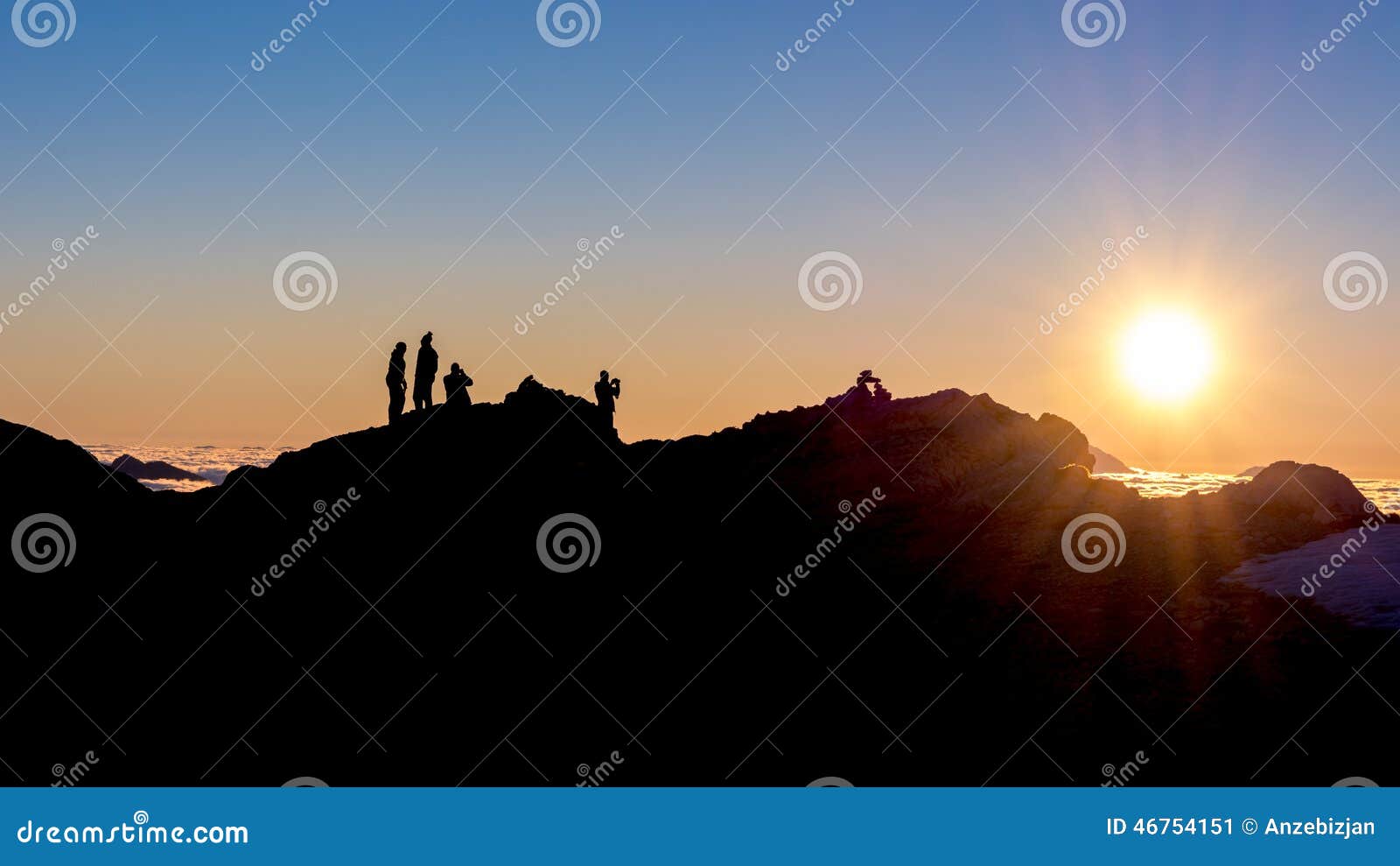 Silhouette of People Standing on a Mountain Ridge Stock Image - Image ...