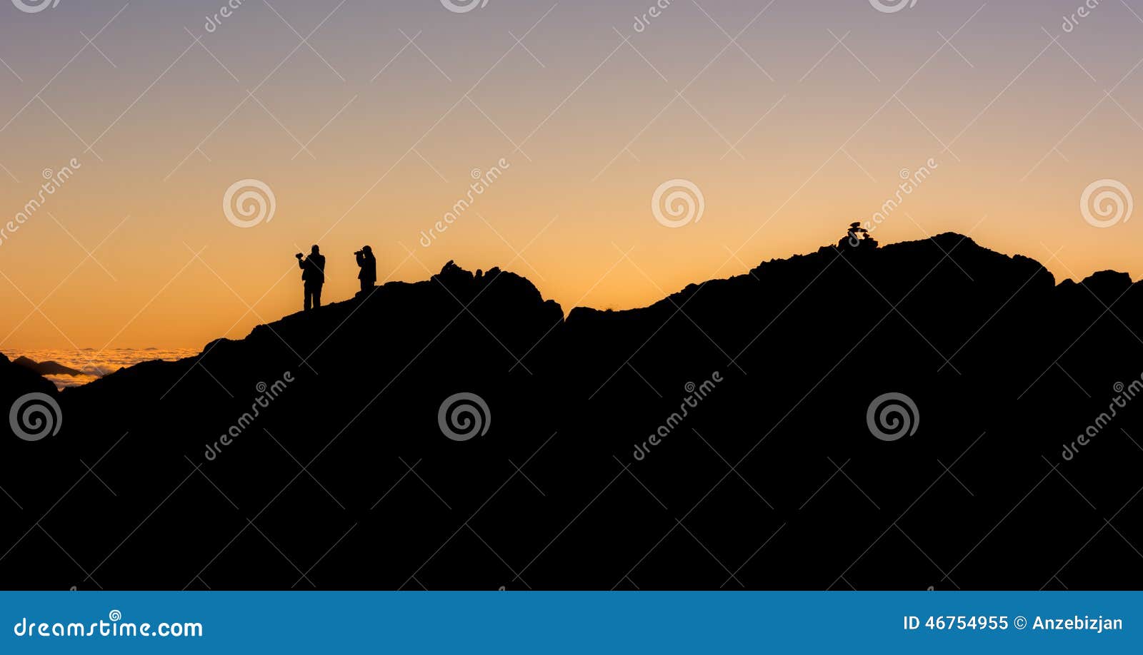Silhouette of People Standing on a Mountain Ridge Stock Image - Image ...