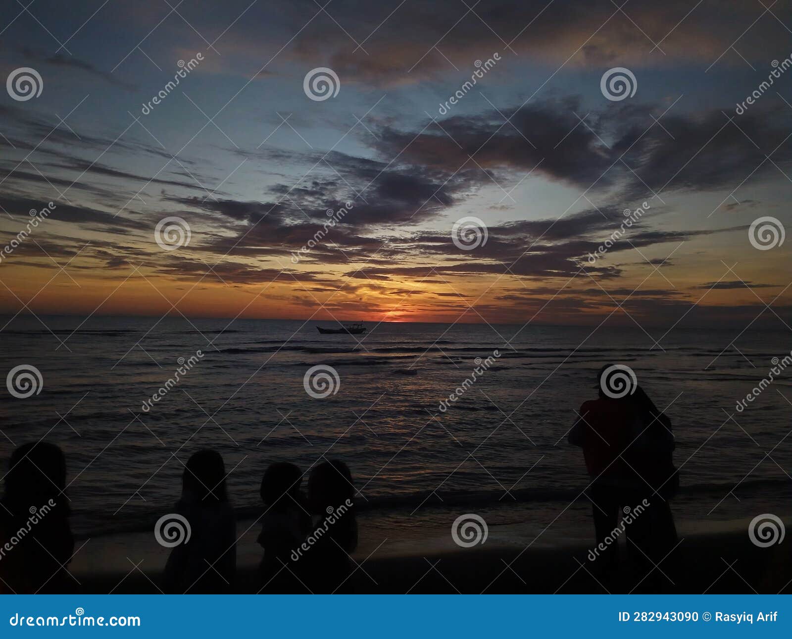 The Silhouette of People with the Sunset As the Background Stock Photo ...