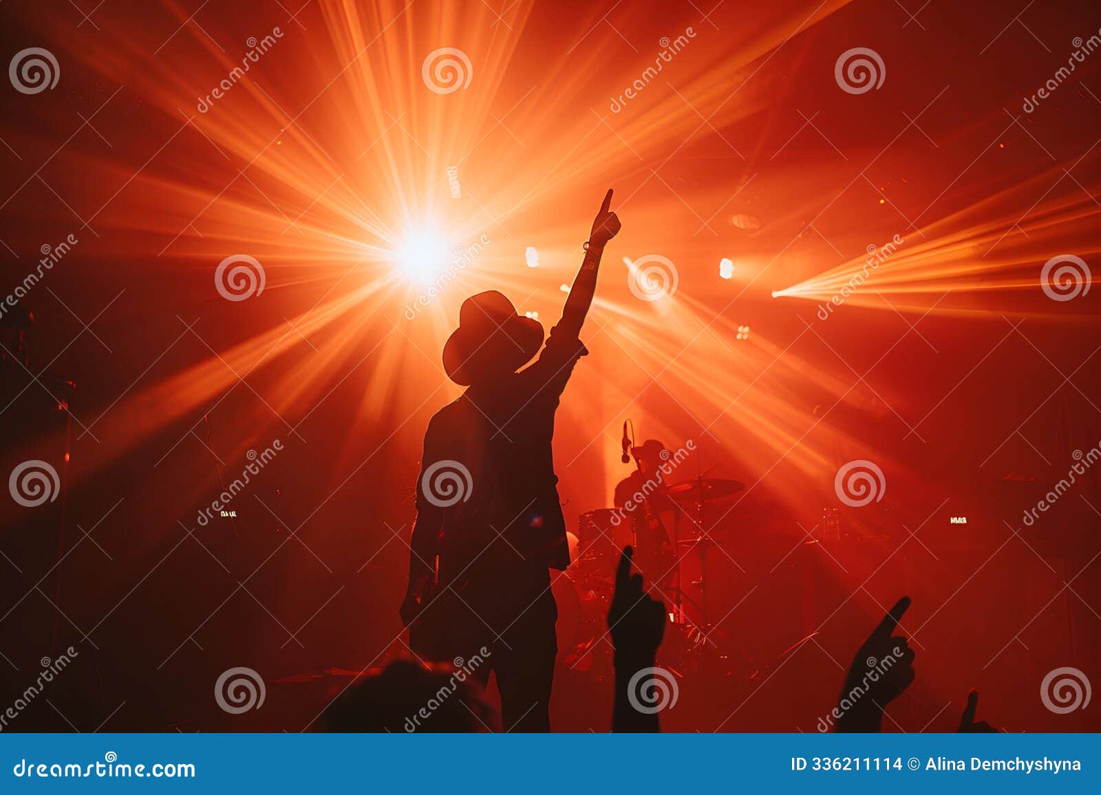 Silhouette of a Performer on Stage Under Intense Red Lighting with ...