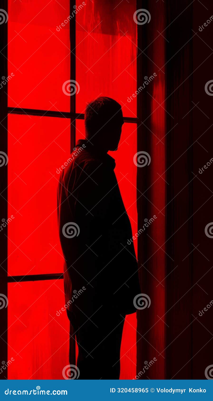 Silhouette of a Person Standing by a Window with Red Light Stock ...