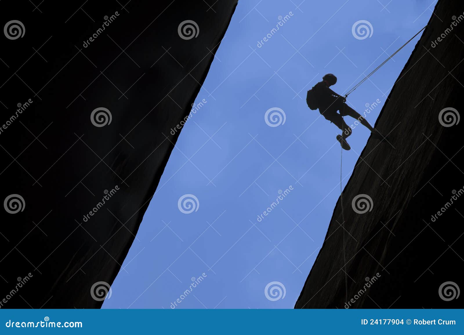 Silhouette of Rock Climber Rappelling Stock Photo - Image of helmet ...
