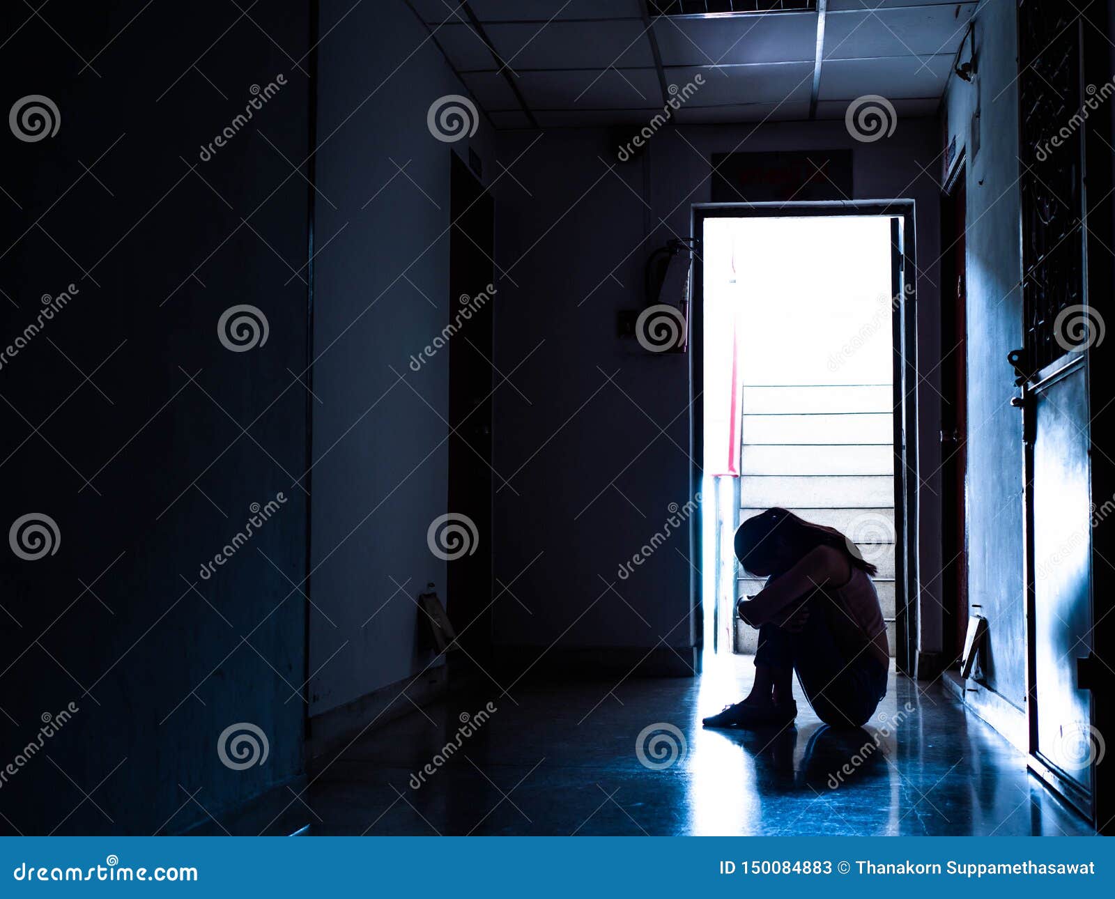 Silhouette of a Sad Young Girl Sitting in the Dark, Thinking about ...