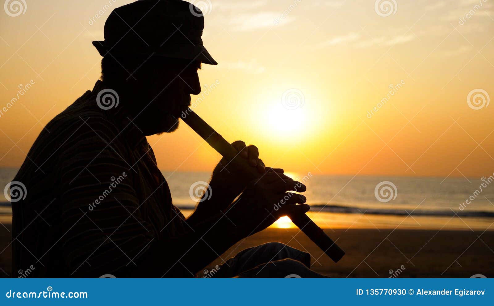 Man Playing Bamboo Instrument With Lagoon Background Royalty-Free Stock ...