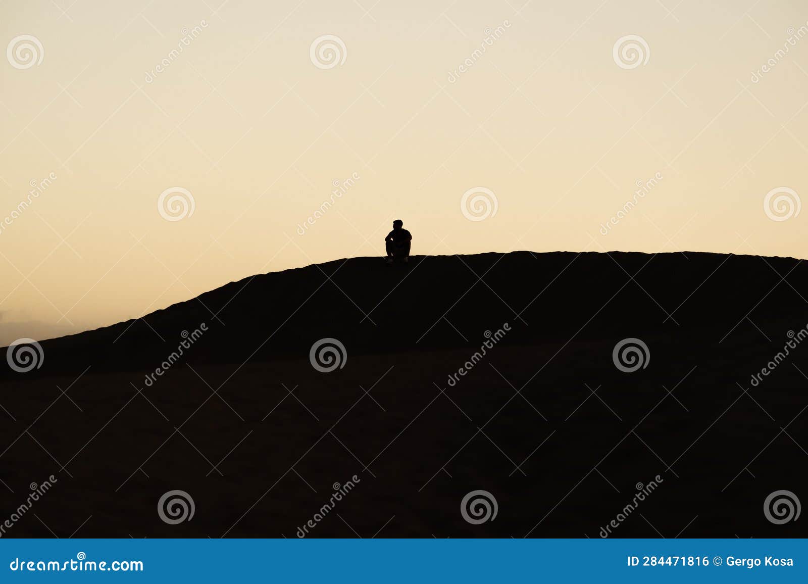 Silhouette of a Single Person Sitting in the Desert Stock Photo - Image ...