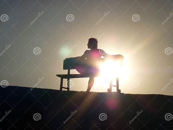 Silhouette Sitting in Sunset Stock Image - Image of person, black: 23321595