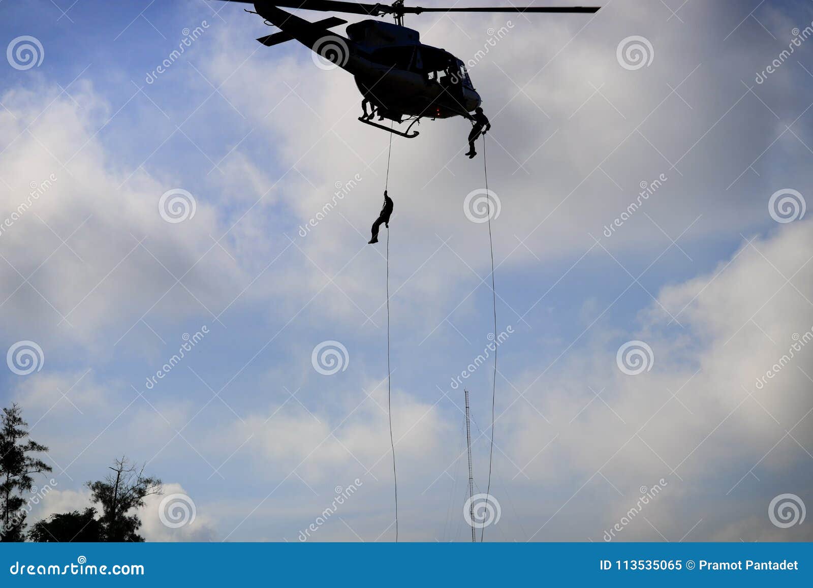 Soldier Rappelling From Helicopter In Blue. Sky With Blur Propell ...