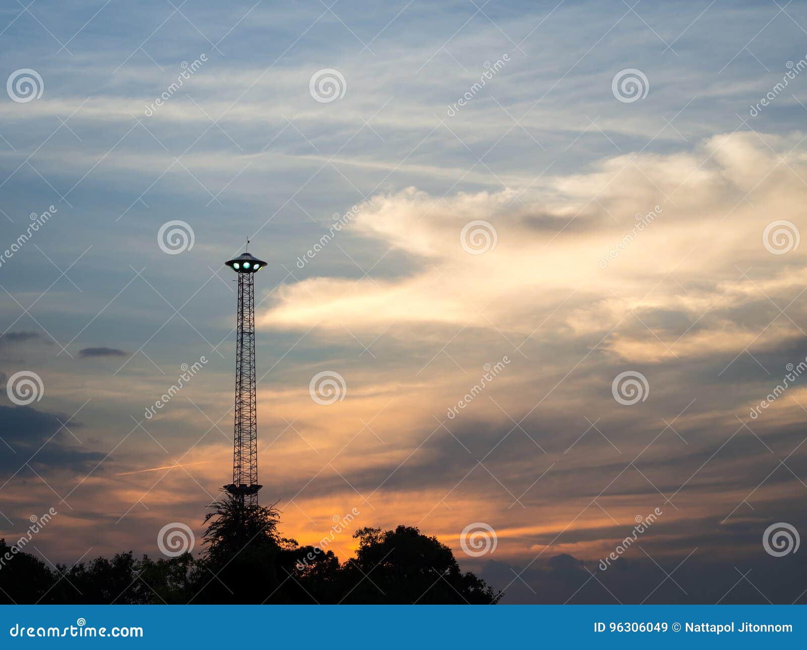 Silhouette Spotlight Pole Like UFO with Sunset and Cloudy Background ...