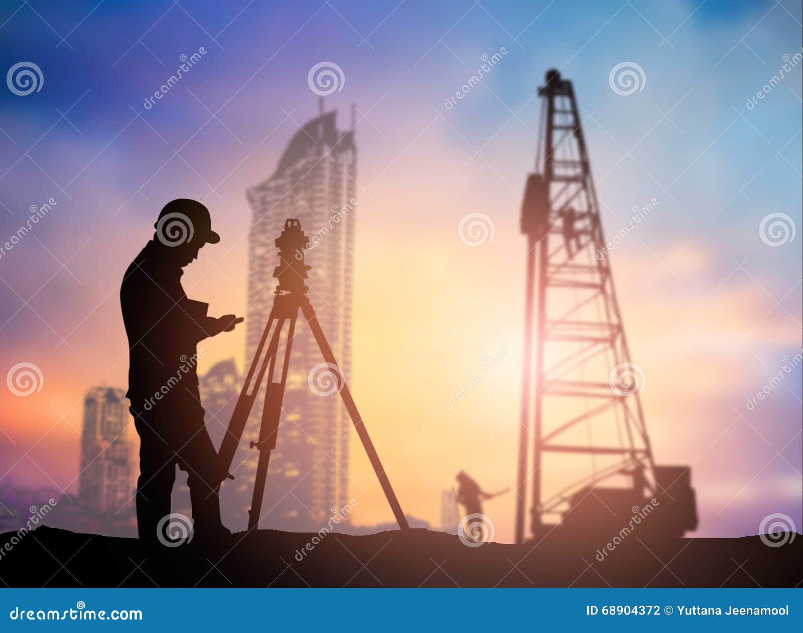 Silhouette Survey Engineer Working in a Building Site Over Blurred ...