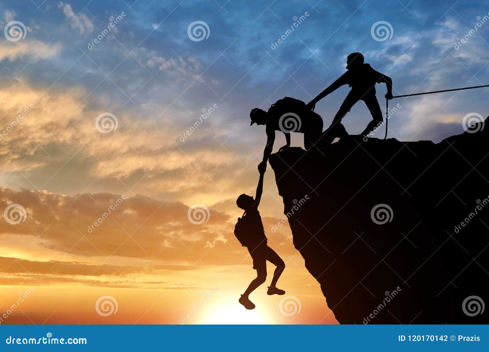 Silhouette of Three Male Climbers Rescuing Another Male Climber Pulling ...