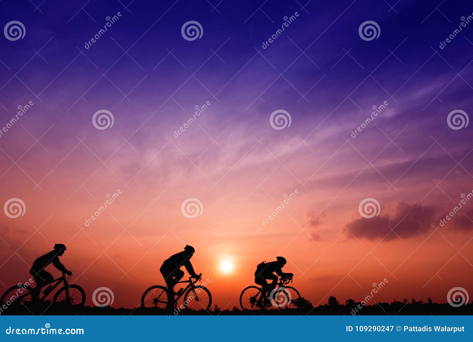 Silhouette Three Men Ride Bikes at Sunset with Orange-blue Sky ...
