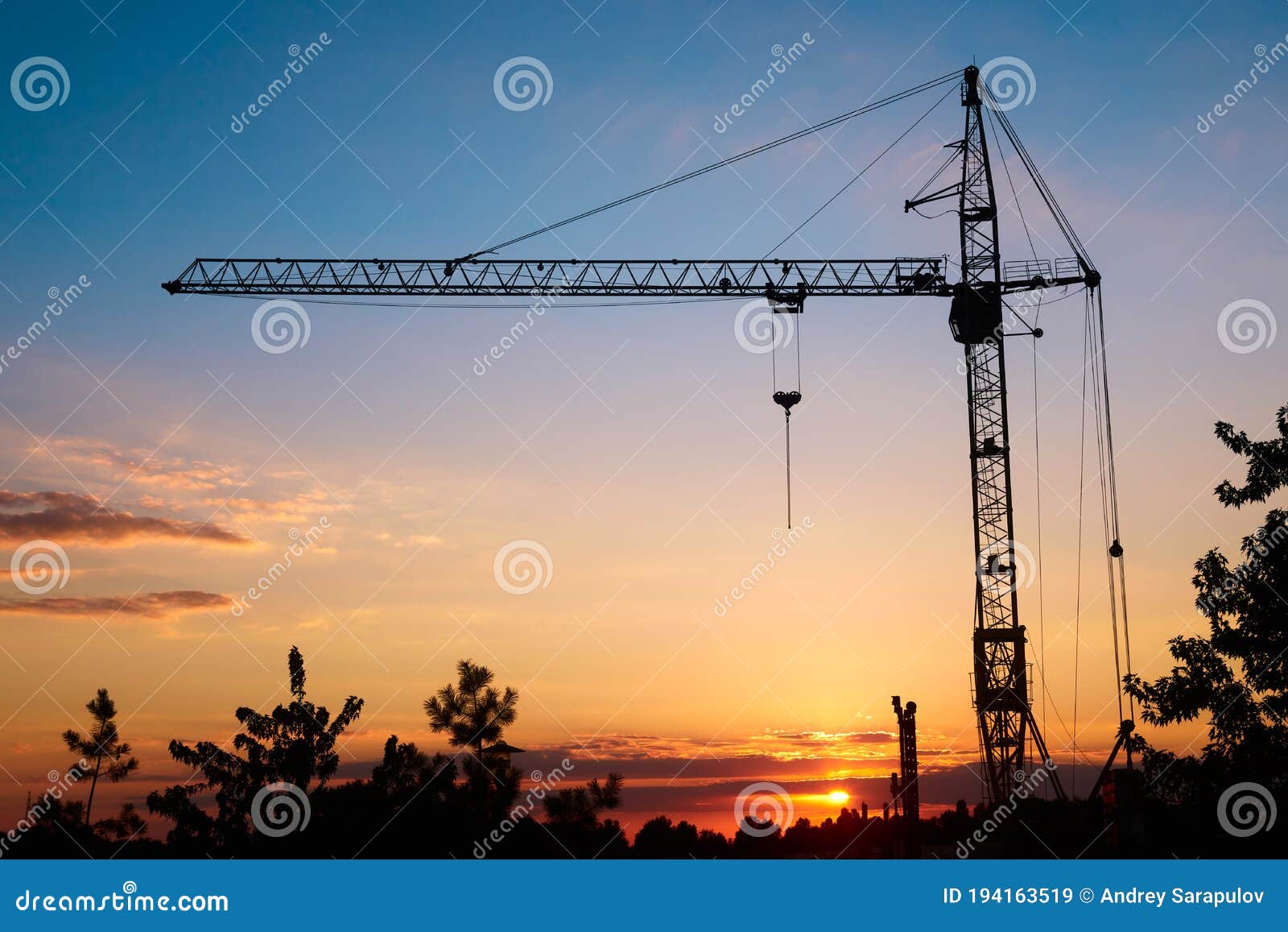 Silhouette Of Tower Crane On Construction Site At Sunset Stock ...
