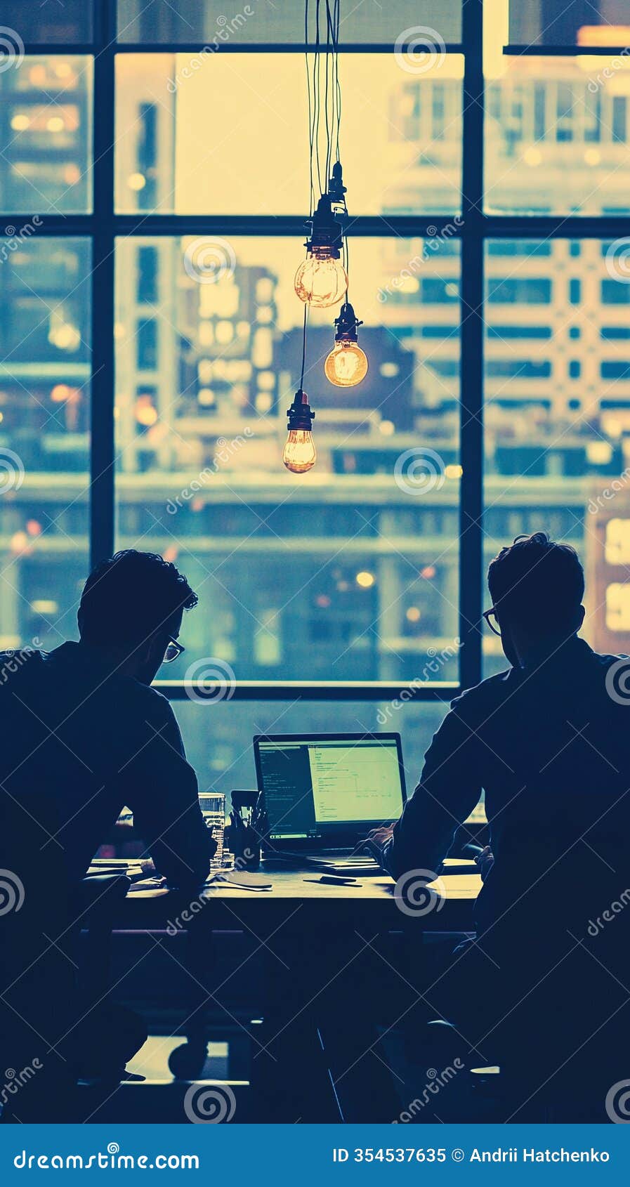 Silhouette of Two Colleagues Brainstorming in a Tech-focused Office ...