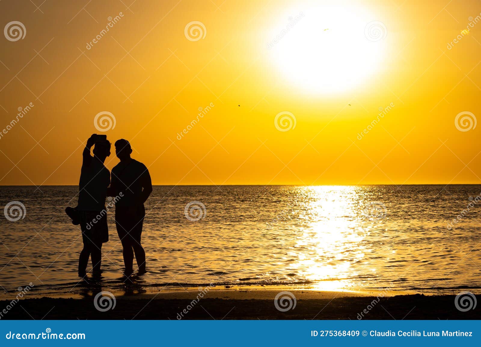 Silhouette of Two Men Taking a Selfie on the Beach at Sunset Stock ...