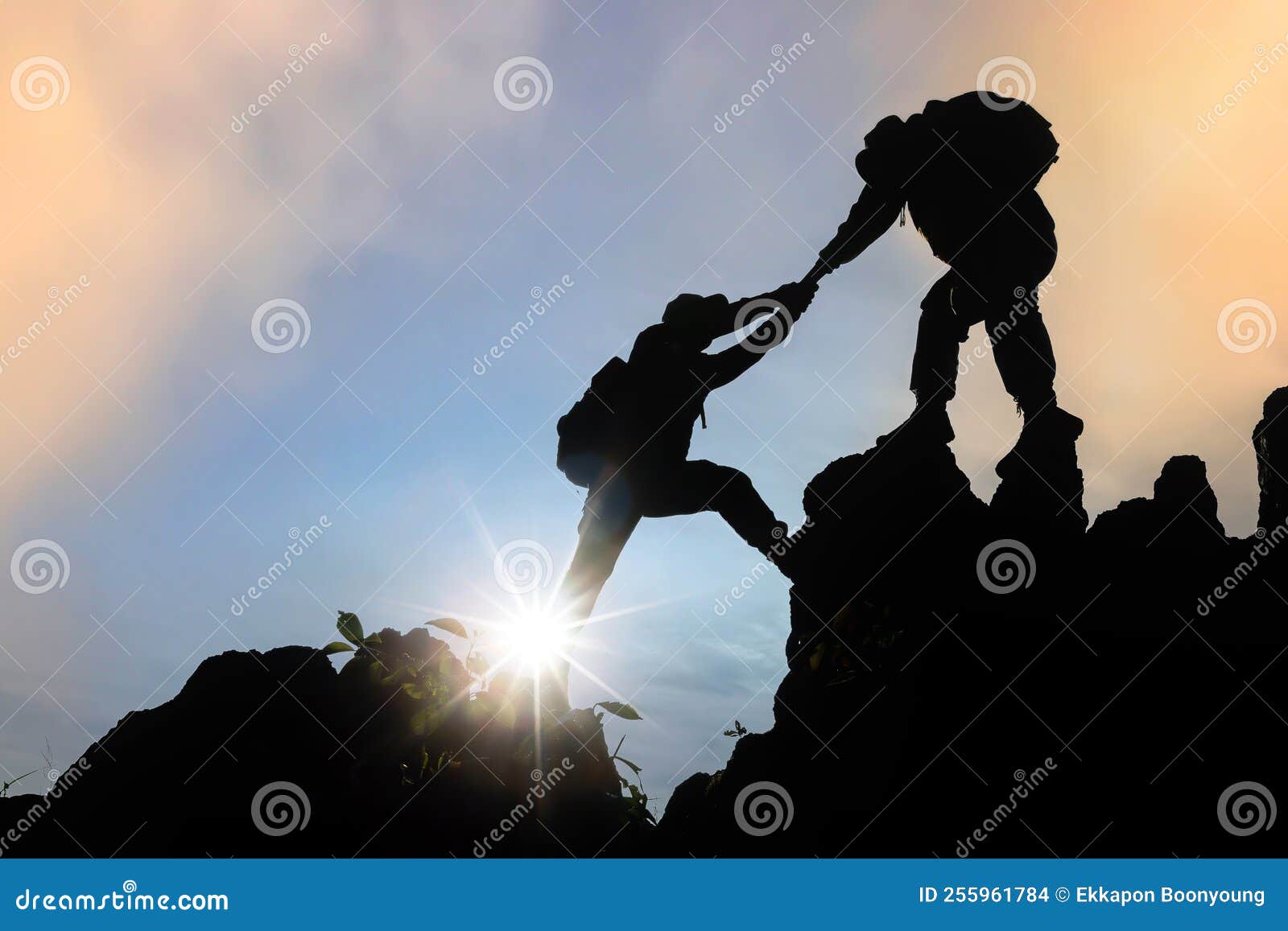 Silhouette of Two People Climbing a Mountain in a Trekking Activity at ...