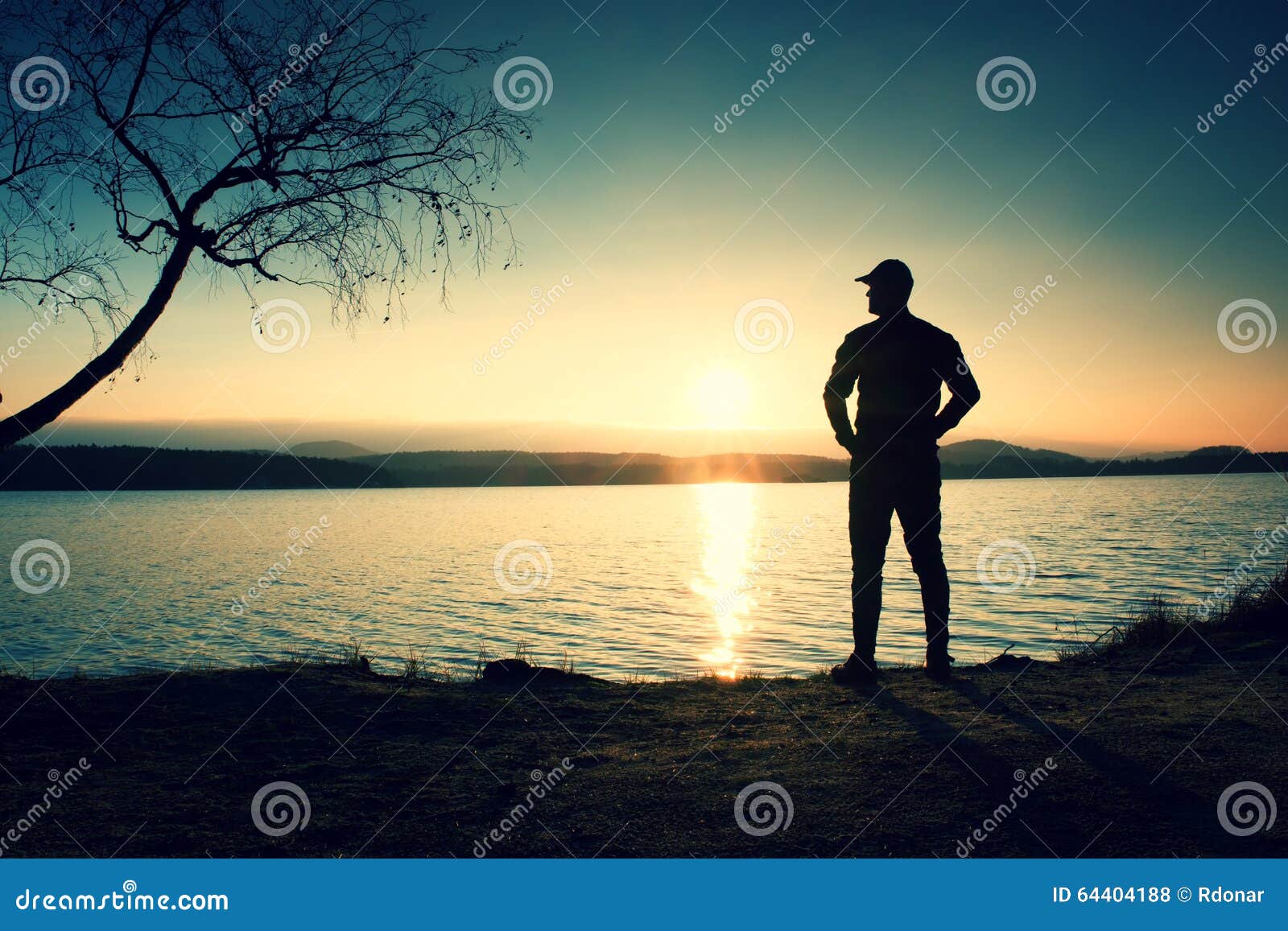 Silhouette of Young Man Stand on Beach at Sunset. Shadow of Active Man ...