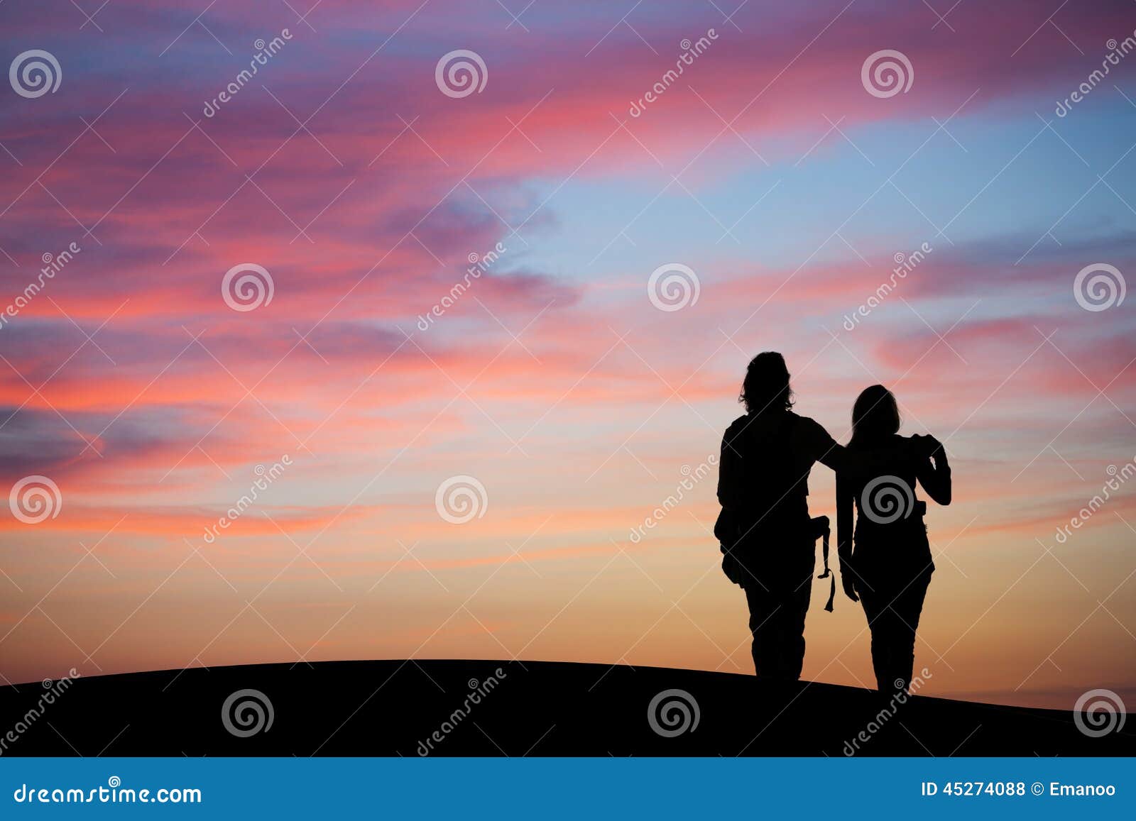 Silhouetted Couple Watching Sunset Sky Stock Photo - Image of ...
