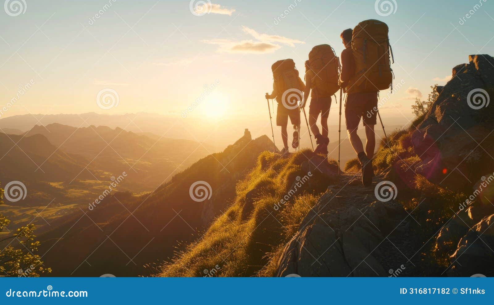 Silhouetted Hikers Stand on Mountain Summit with a Stunning Sunset ...